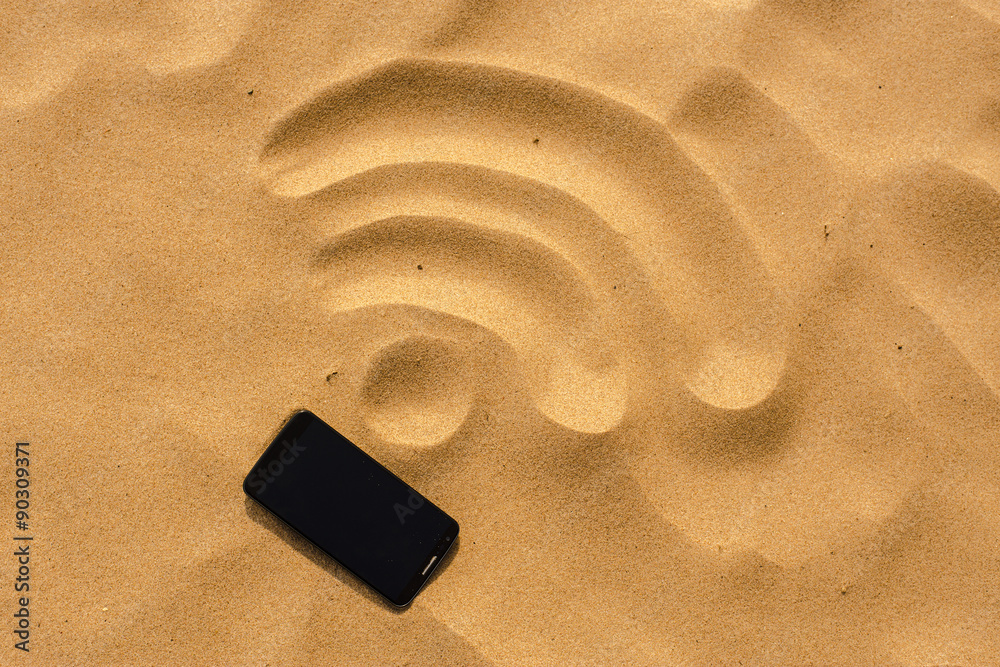mobile phone lying on the beach, in the sand, which drafted the WiFi ...