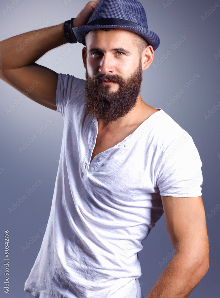 Portrait of handsome bearded man in hat standing , isolated on Stock ...