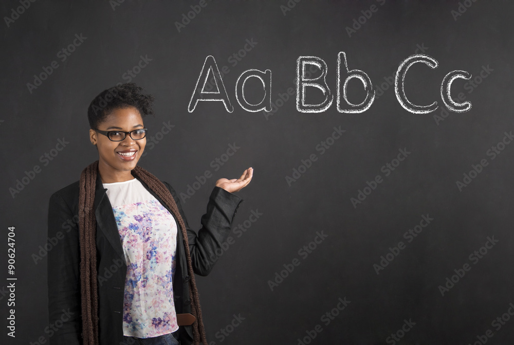 African American woman showing the ABC alphabet against blackboard ...