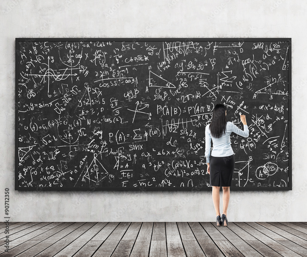 Full length of the rear view of the brunette girl who is writing down ...