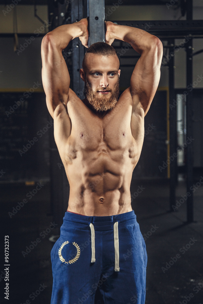Shirtless bodybuilder in blue pants. Stock Photo | Adobe Stock