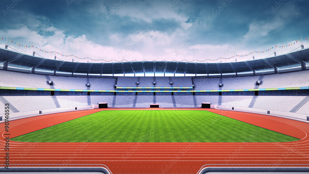 empty athletics stadium with track and grass field at side day view ...