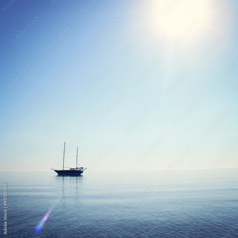 Sailing ship profile. Toned image. Sunbeams on the sea surface. Morning ...
