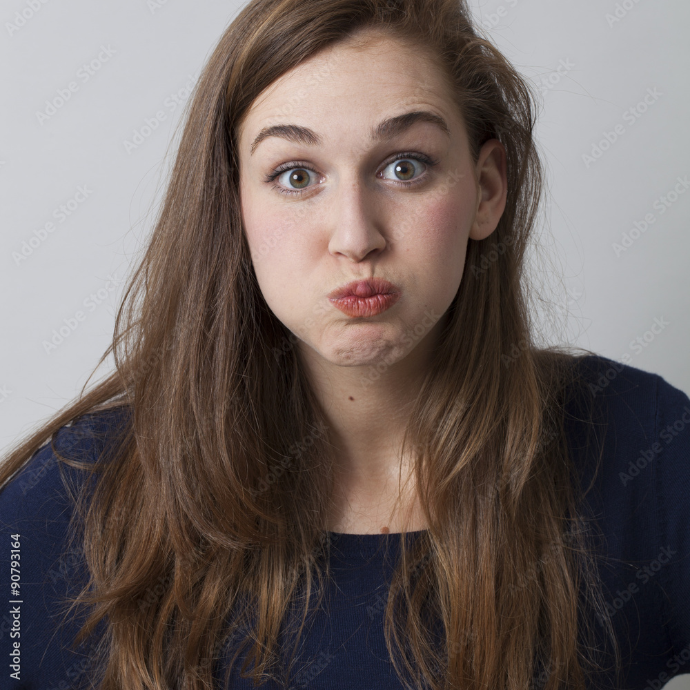 surprised beautiful 20s girl puffing her cheeks out Stock Photo | Adobe ...
