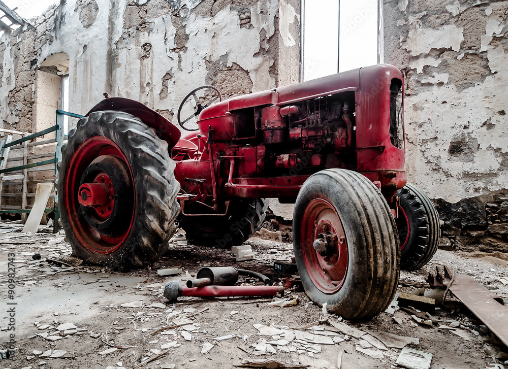 Old, broken tractor indoors Stock Photo | Adobe Stock