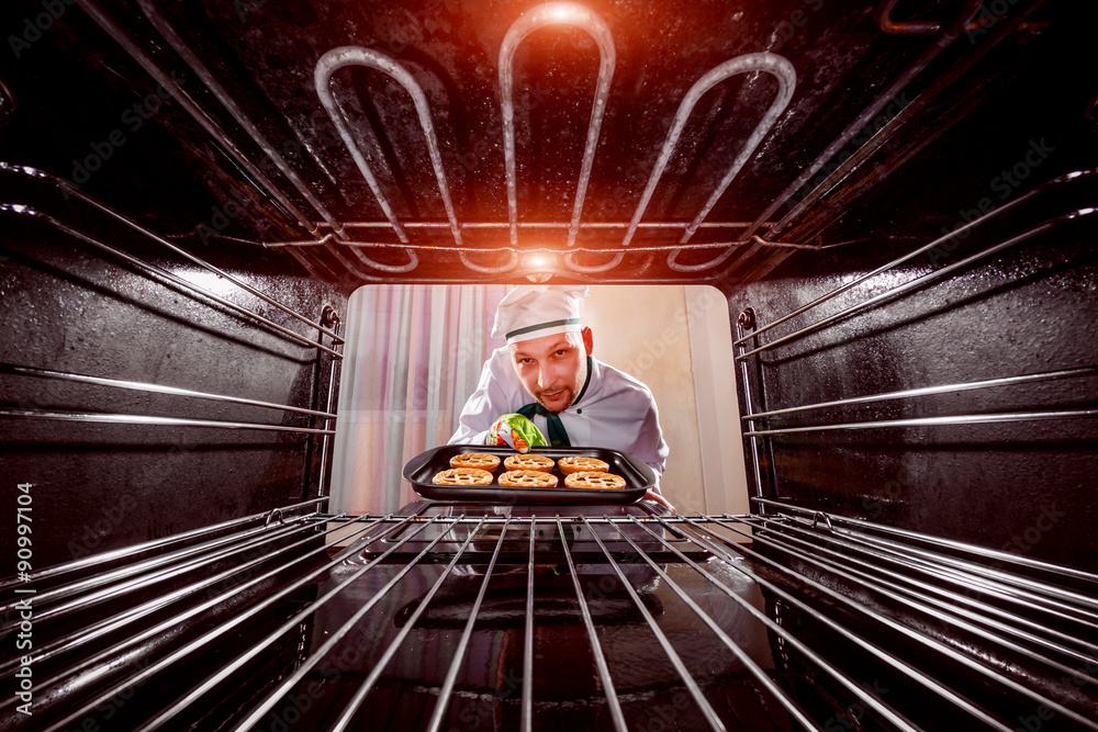 Chef cooking in the oven. Stock Photo | Adobe Stock