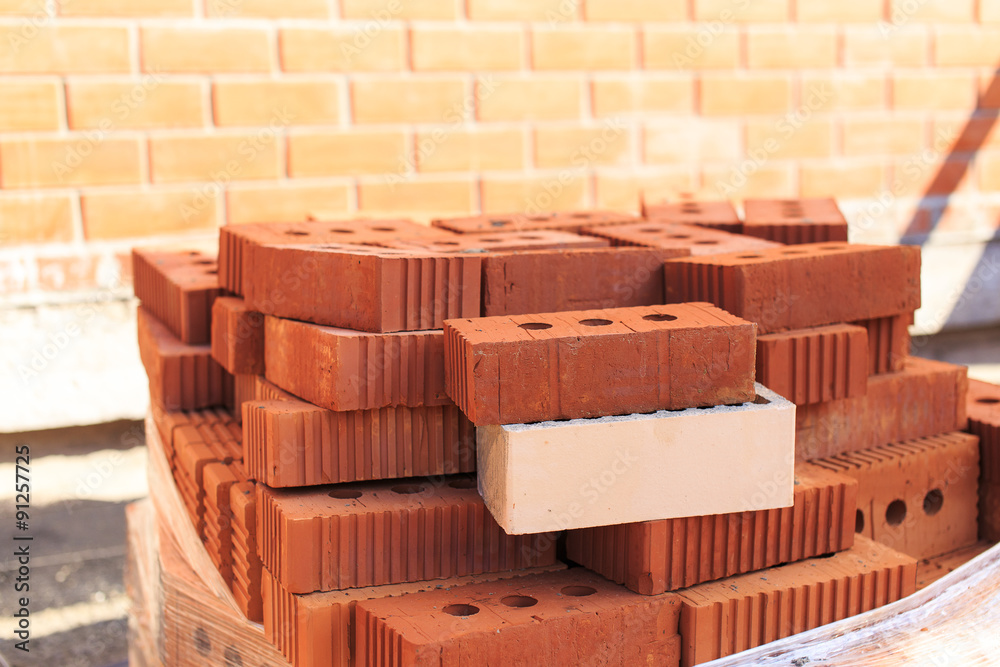 pallet bricks on a building site. pallet perforating bricks at a ...