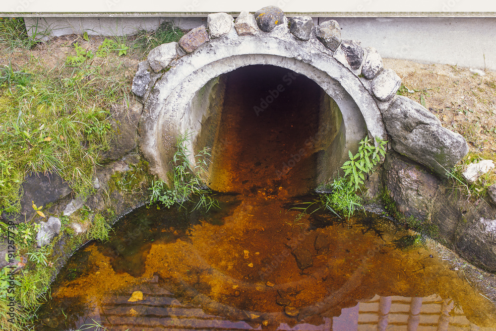 rusty water. rusty water flows through the concrete pipe outdoors Stock ...