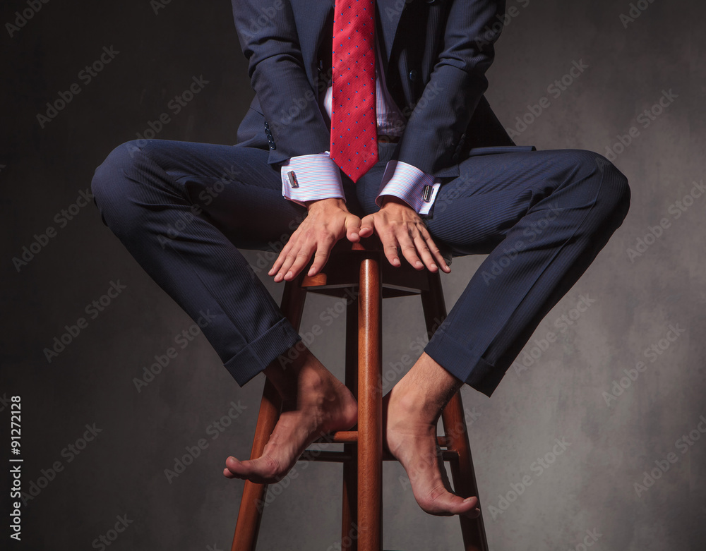 Barefoot business man sitting on a stool Stock Photo | Adobe Stock