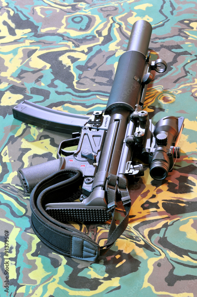 Nine millimeter automatic sub-machine gun attached with dot laser ...