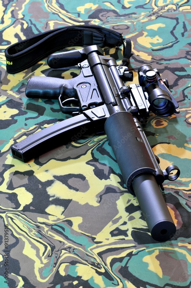 Nine millimeter automatic sub-machine gun attached with dot laser ...