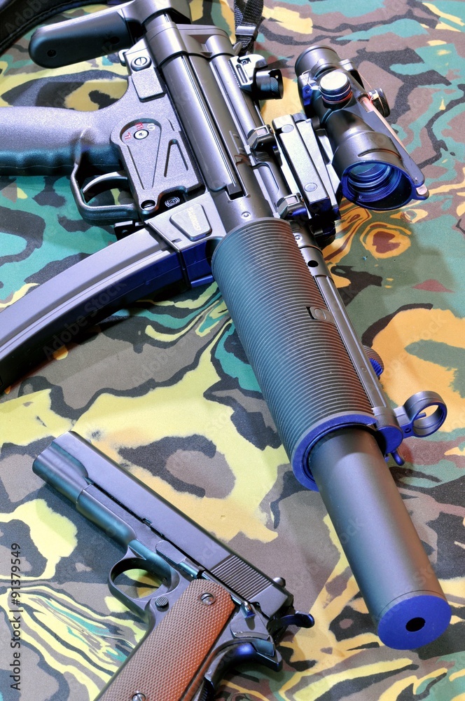 Nine millimeter automatic sub-machine gun attached with dot laser ...