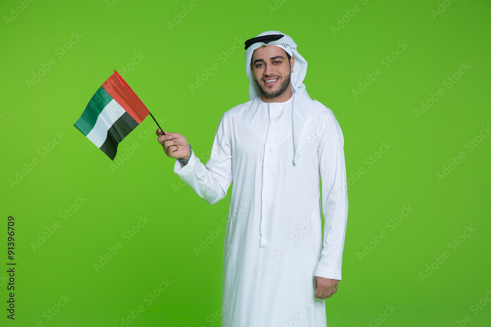 Emirati man holding UAE national flag. Stock Photo | Adobe Stock