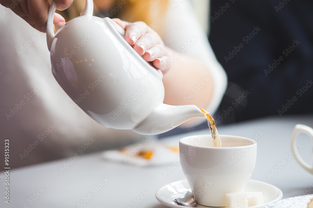 female pouring tea Stock Photo | Adobe Stock