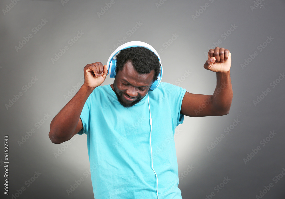 African American man with headphones on grey background Stock Photo ...