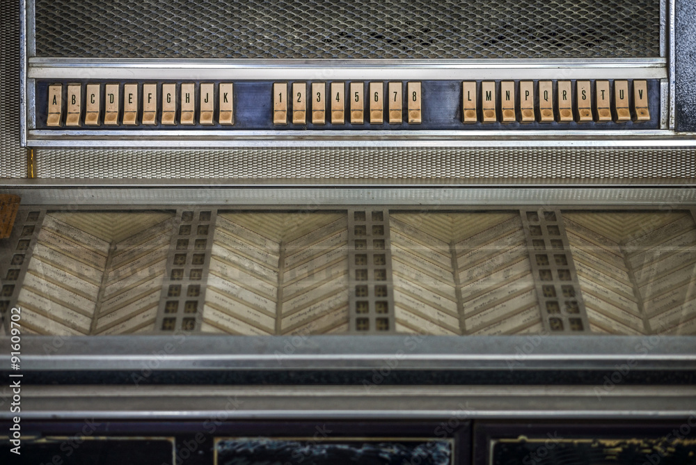 Control panel of old classic jukebox. It has playlists and buttons with ...