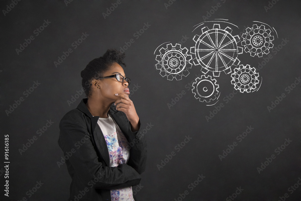 African woman with hand on chin thinking with gears on blackboard ...