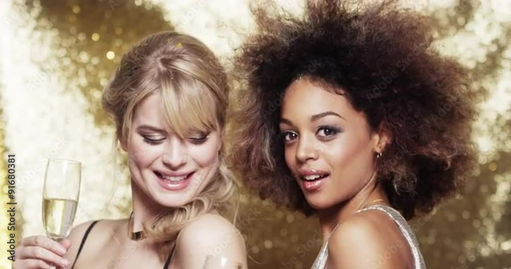 Women celebrating new years party with champagne dancing gold glitter ...