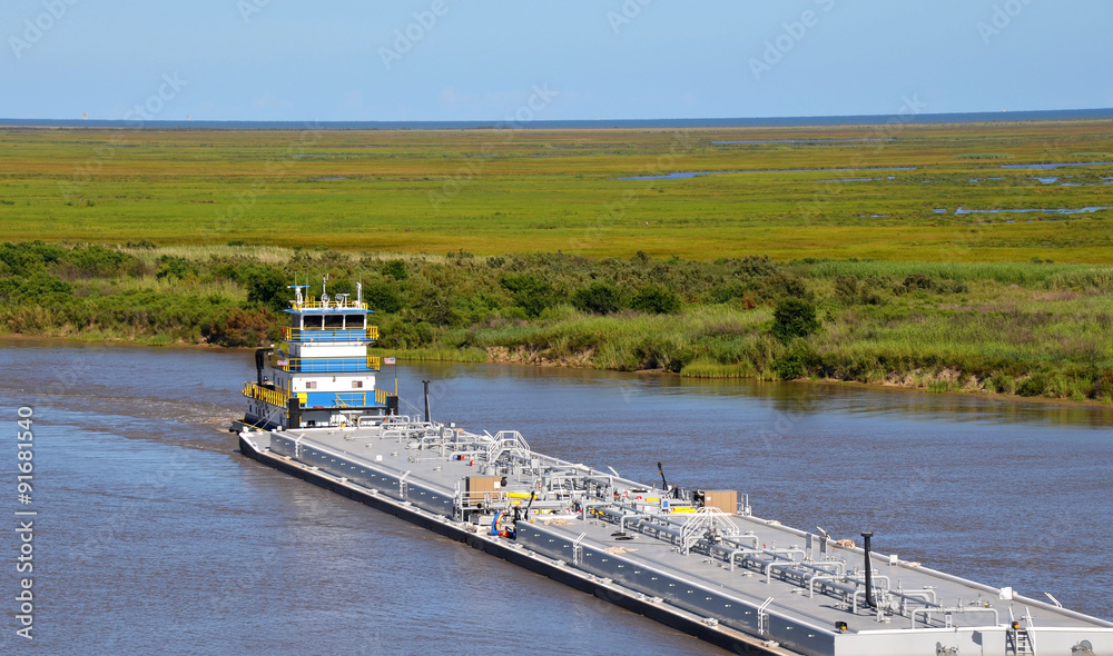 Oil barge being pushed by a tugboat Stock Photo | Adobe Stock