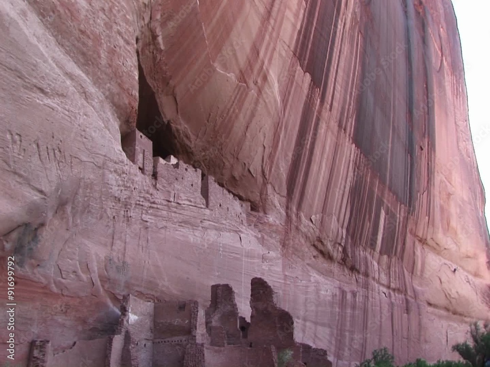 Pan-down shot of cliff dwellings in Canyon De Chelly National Monument ...