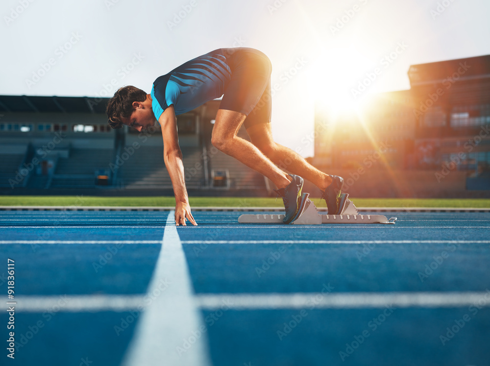Professional male track athlete in set position Stock Photo | Adobe Stock