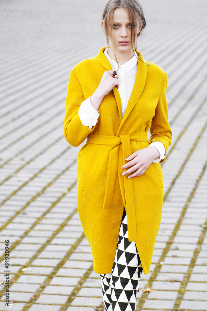 Fashion model in stylish clothes poses outdoors Stock Photo | Adobe Stock