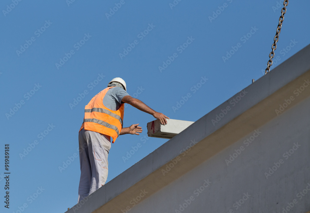 Height worker placing truss on building skeleton Stock Photo | Adobe Stock
