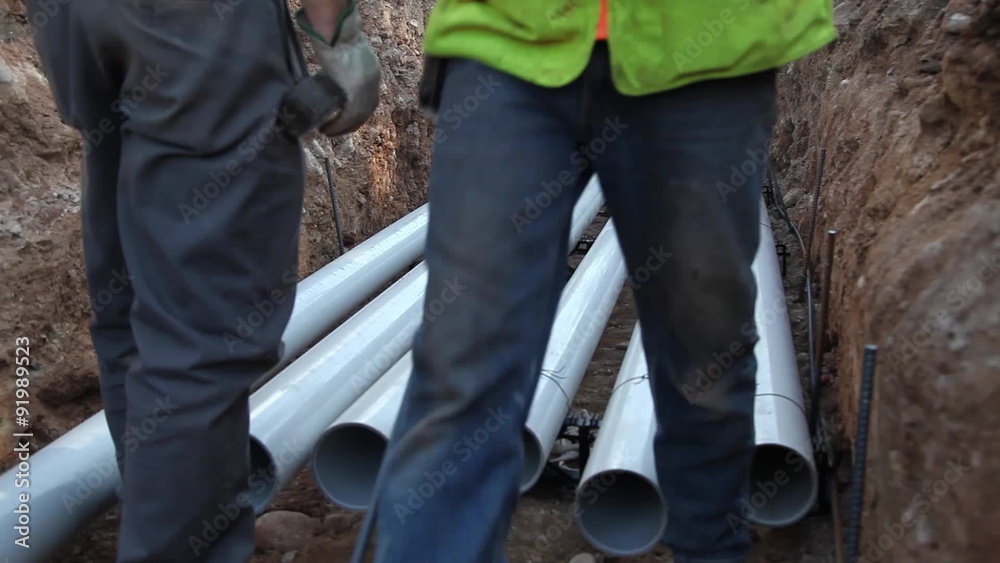 Construction Workers Laying Pipe in Ground Stock Video | Adobe Stock