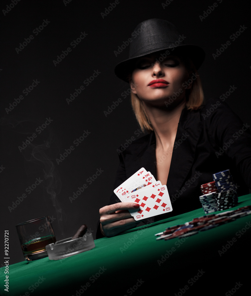 Beautiful young woman playing poker Stock Photo | Adobe Stock