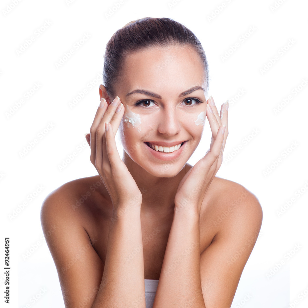beautiful model applying cosmetic cream treatment on her face on white ...