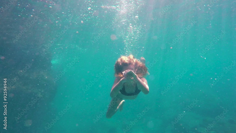 Woman Swimming Underwater In Slow Motion. Swimming Towards Camera by ...