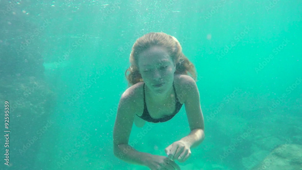 Woman Swimming Underwater In Slow Motion. Swimming Towards Camera by ...