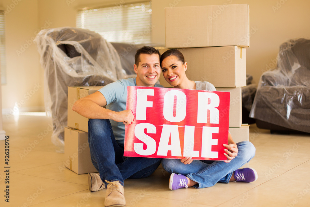 moving couple holding for sale sign Stock Photo | Adobe Stock