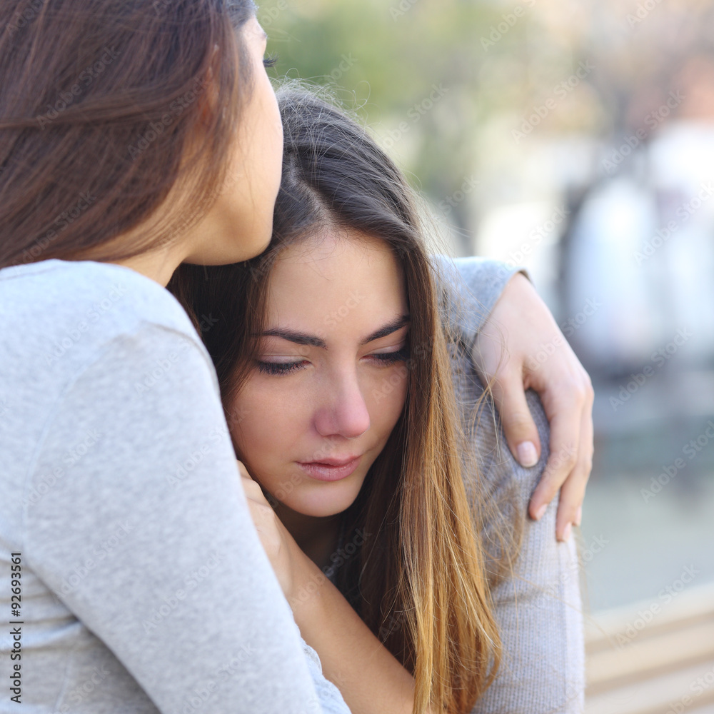Sad girl crying and a friend comforting her Stock Photo | Adobe Stock