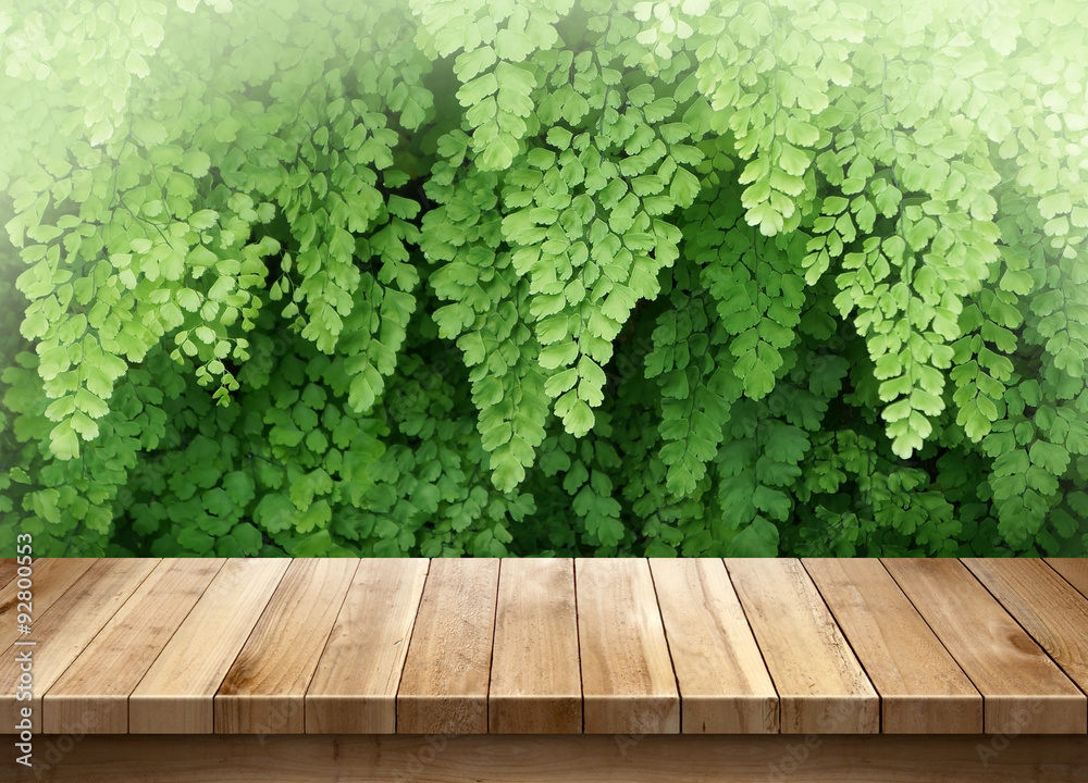Wood table with green leaves background Stock Photo | Adobe Stock