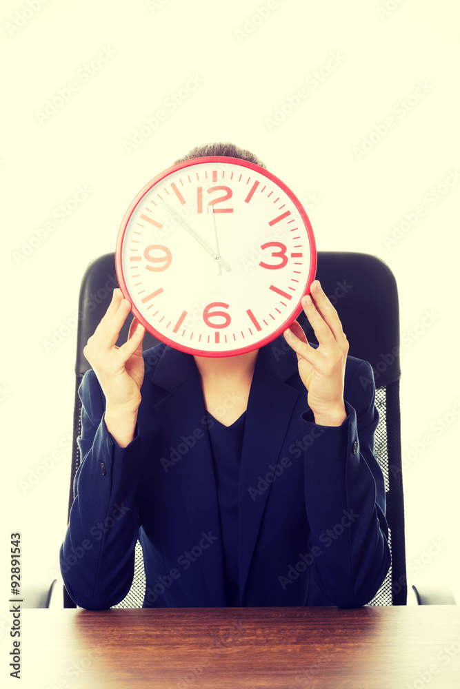 Businesswoman sitting with big clock at the office Stock Photo | Adobe ...