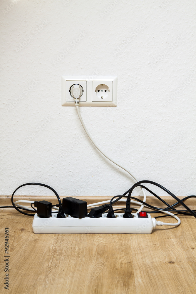 Plugged in electric devices in an extension cord, with wall socket ...