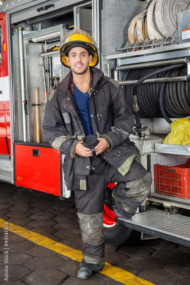 Smiling Fireman Standing By Truck At Fire Station Stock Photo | Adobe Stock