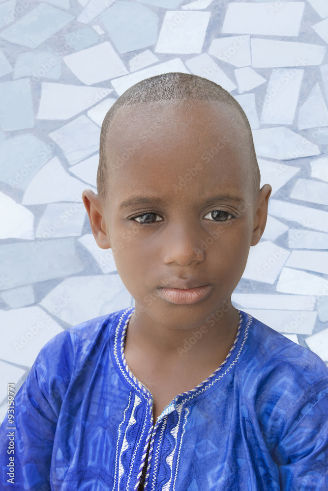 portrait-of-a-five-year-old-boy-wearing-a-blue-garment-stock-photo