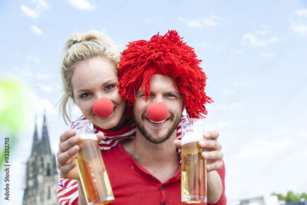 Germany, Cologne, young couple celebrating carnival dressed up as ...