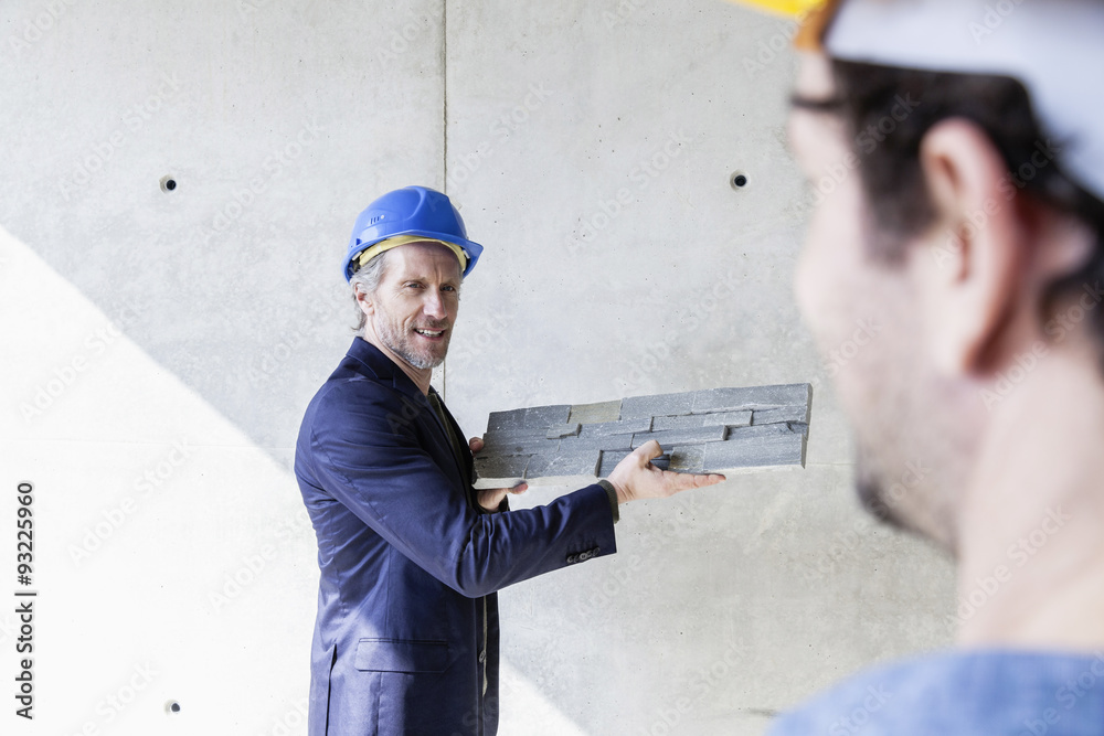 Architect showing sample on construction site Stock Photo | Adobe Stock