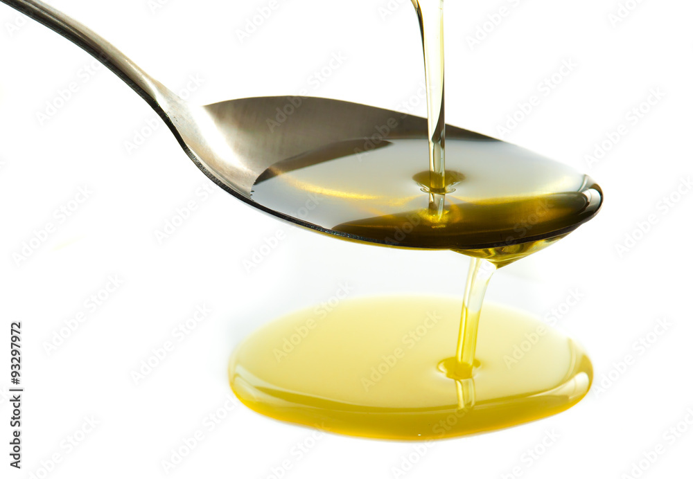 Pouring oil on spoon isolated on white, Stock Photo | Adobe Stock