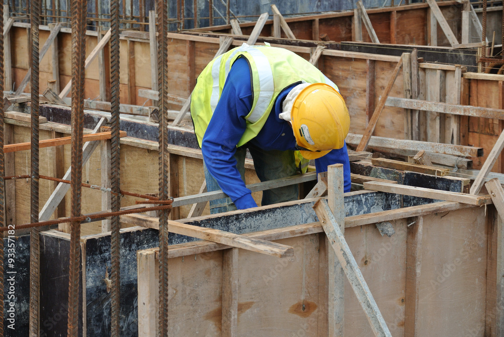 Construction workers fabricate ground beam formwork Stock Photo | Adobe ...