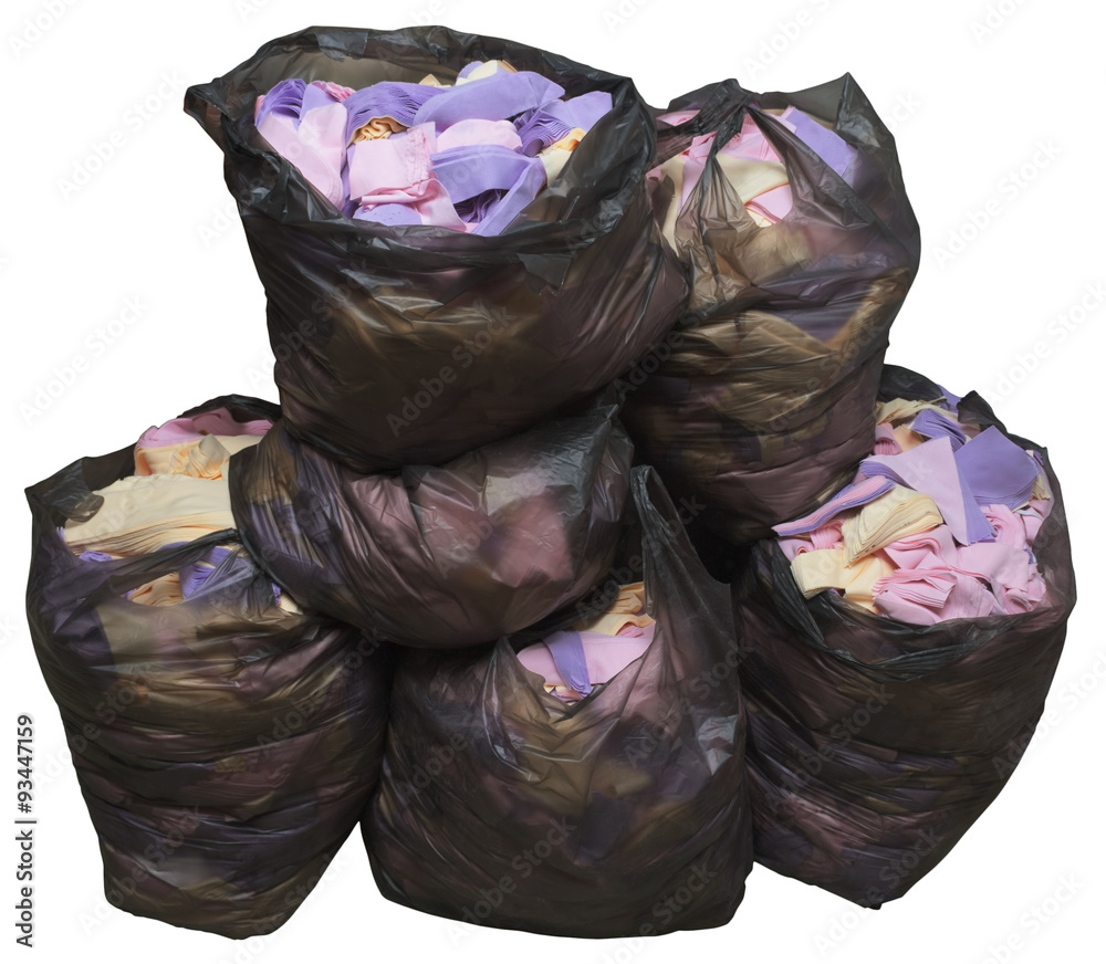 Textile waste in bags. Isolated on white background without shadows ...