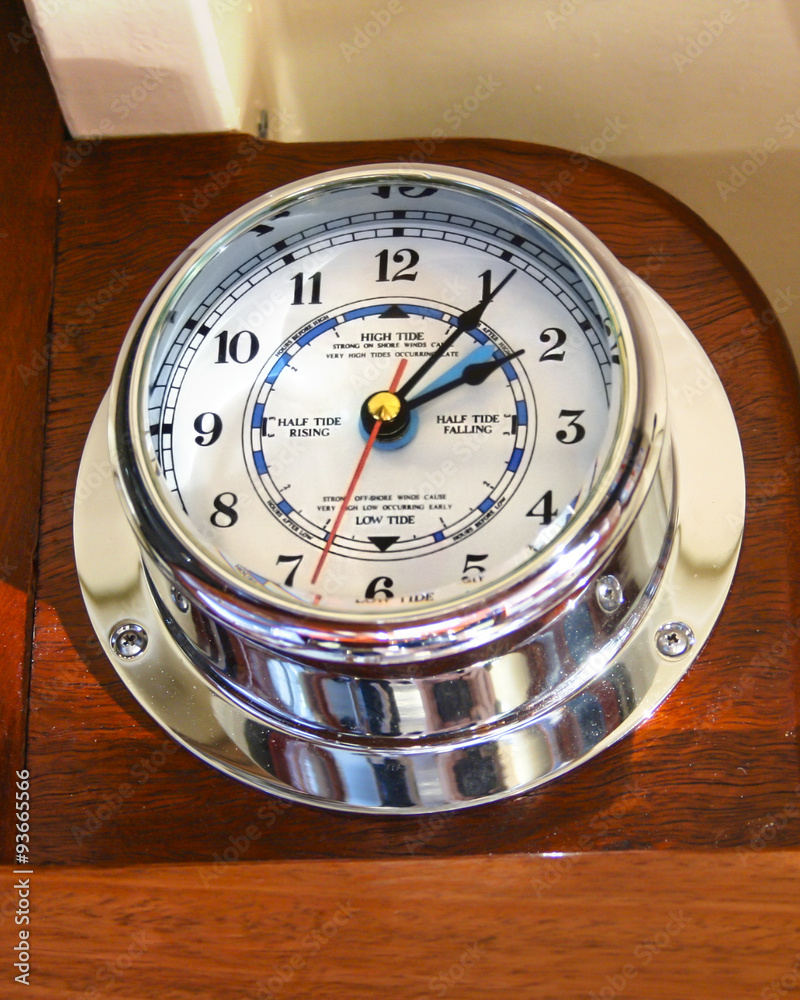Chrome marine tide clock mounted to wood on a ferry. Stock Photo ...