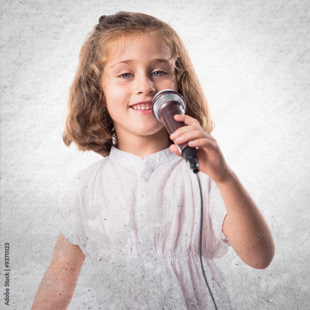 Girl singing with microphone Stock Photo | Adobe Stock