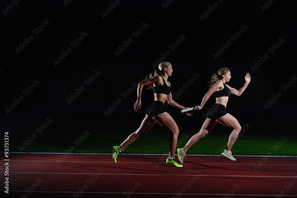 athletic runners passing baton in relay race Stock Photo | Adobe Stock