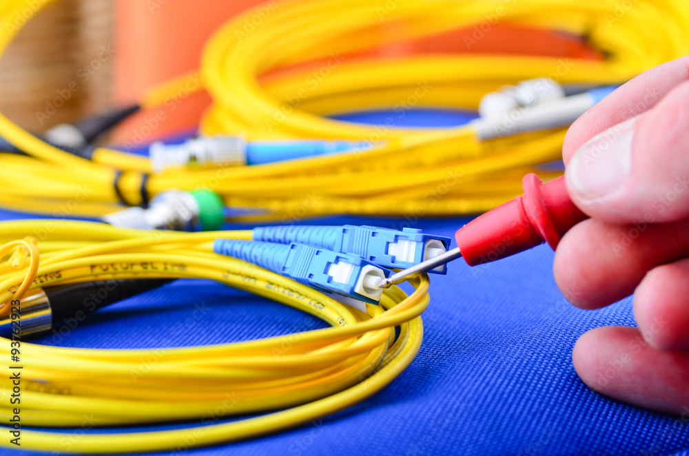 Engineer testing fiber optic cables. Stock Photo | Adobe Stock