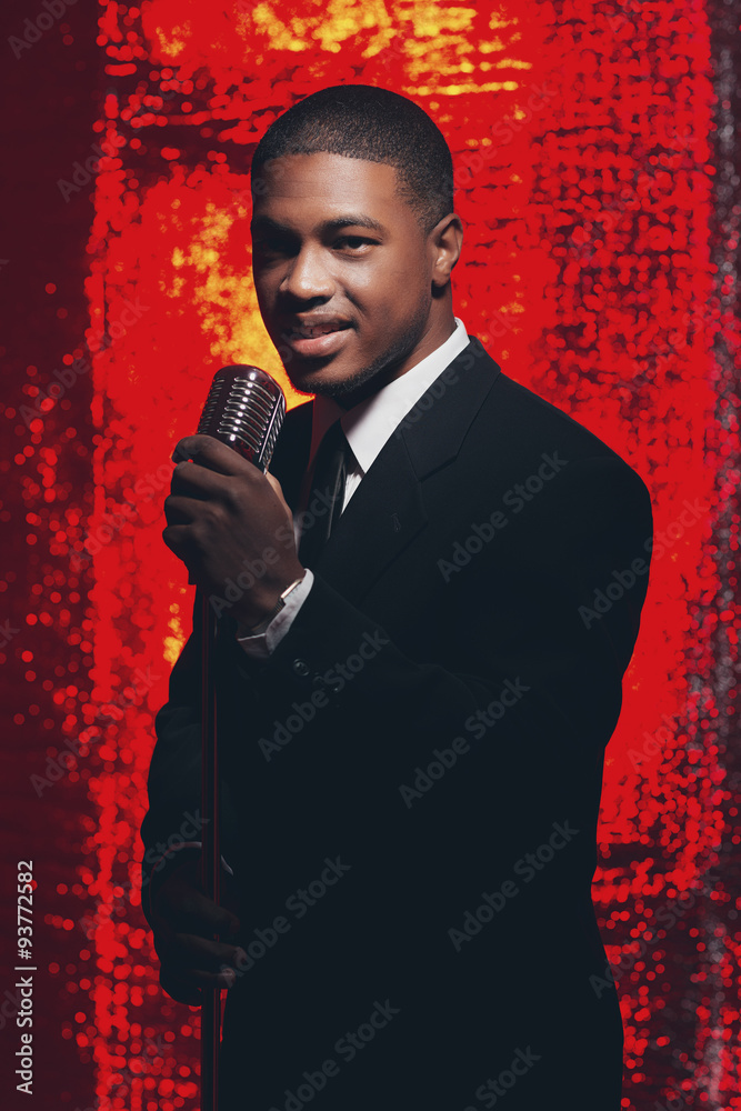 Smiling retro 50s male african american singer in black suit and Stock ...