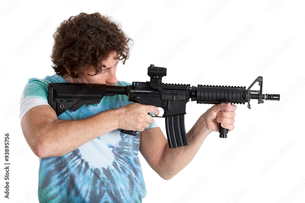 Side view of curly hair adult man aiming with black machine gun ...